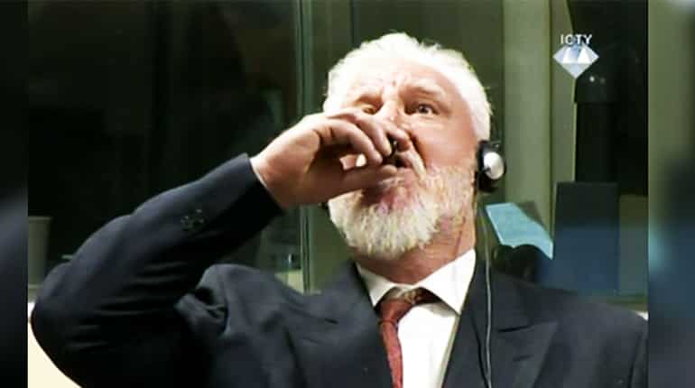 War crimes accused takes 'poison' in Hague dock - World News