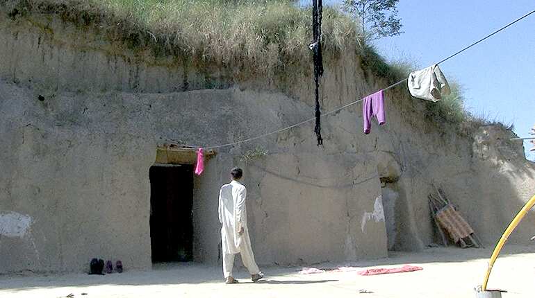 In Pakistani village, home is where the cave is - South Asia News