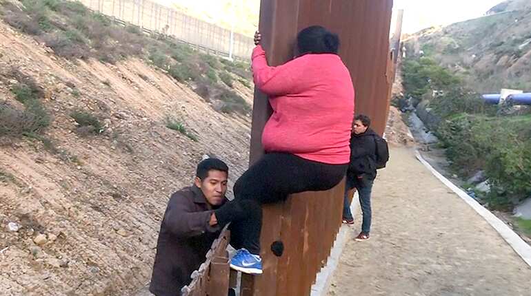 Migrant families jump Tijuana border fence, head to US - World News