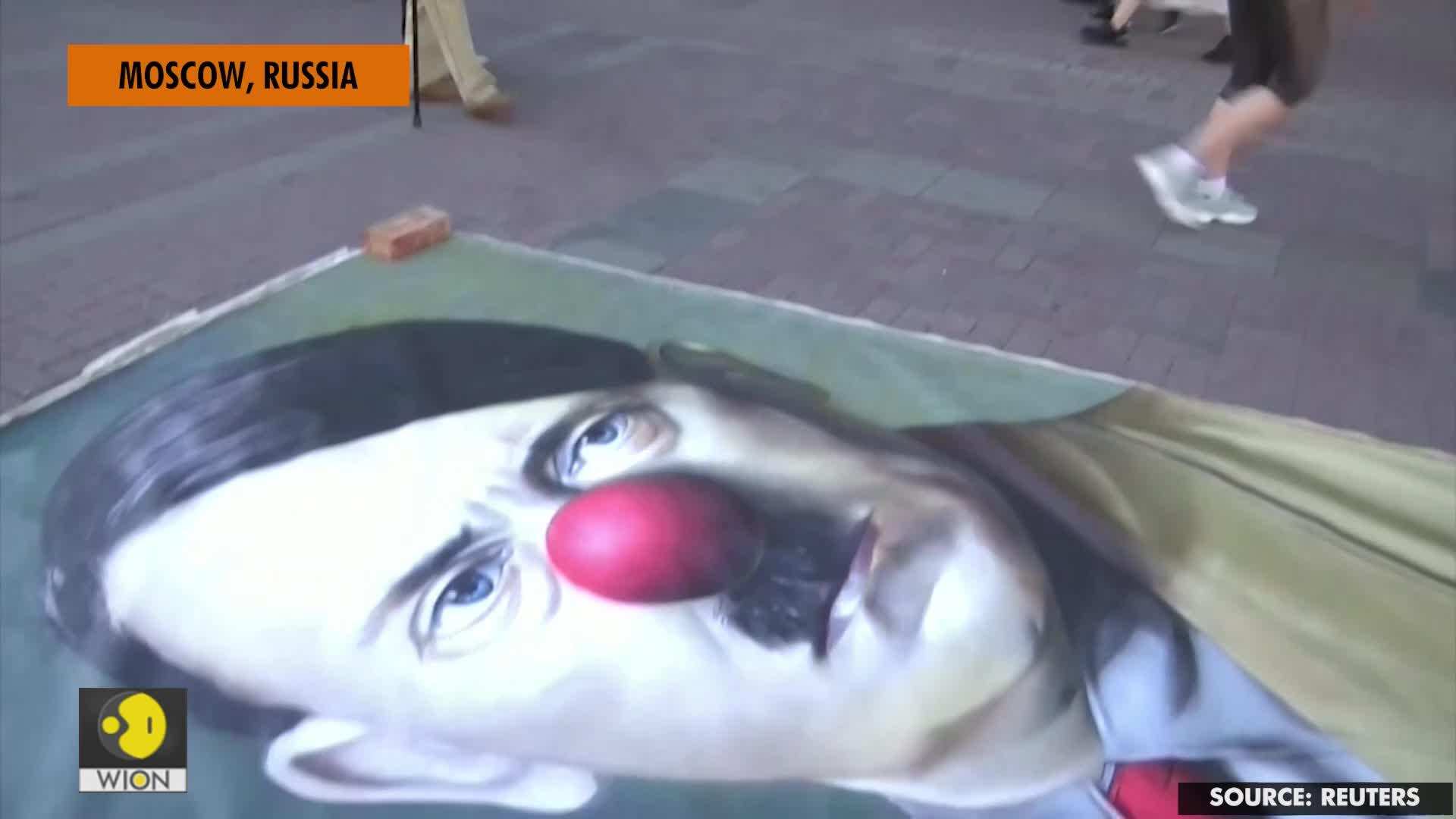 Hitler's portrait defaced as Russian artist tests public opinion of WW2 ...
