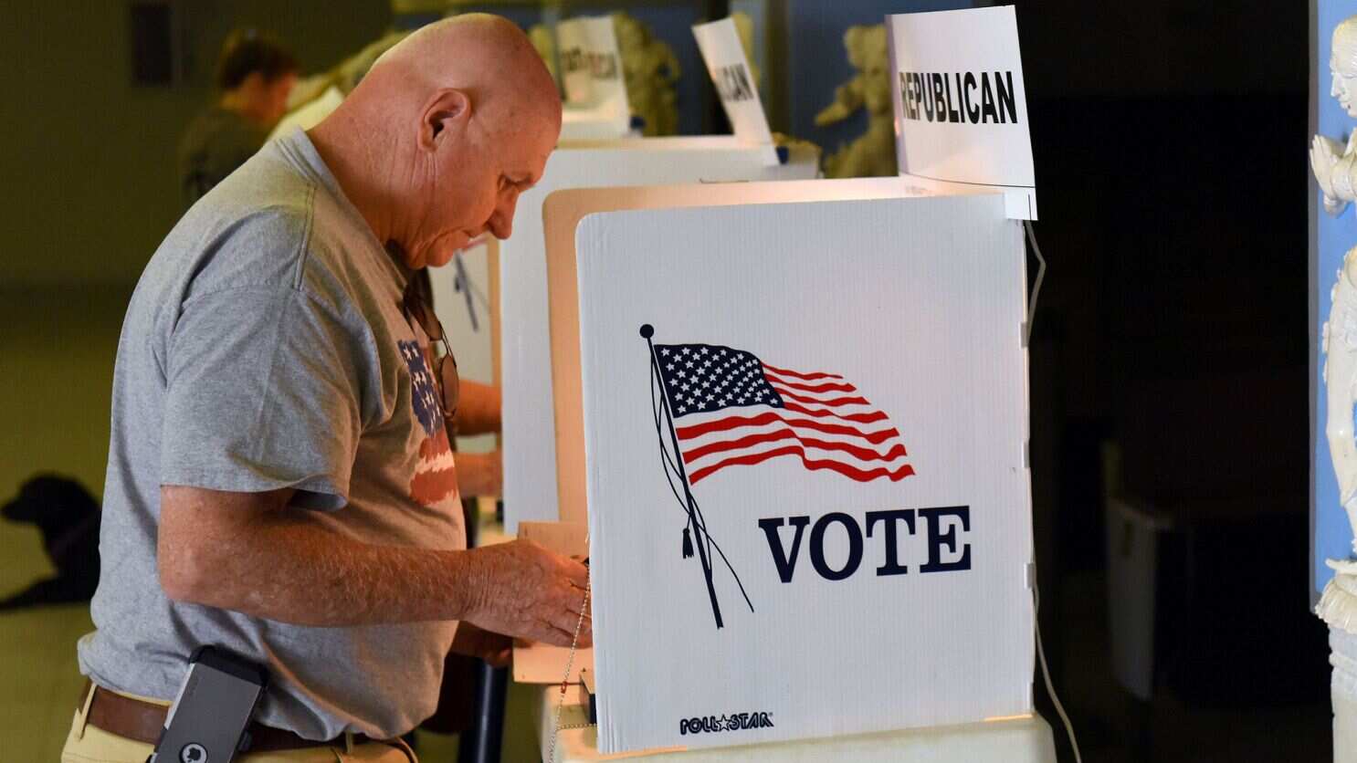 People cast their ballots in secured boxes as early voting for US ...