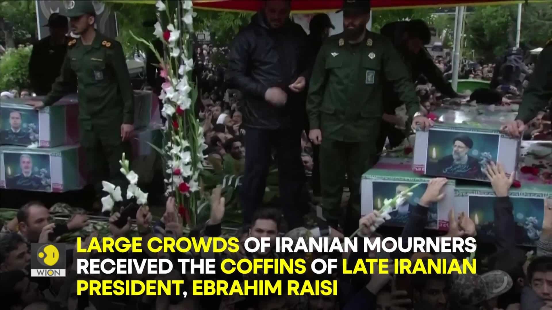 Ebrahim Raisi's funeral: Iranian mourners receive Raisi's coffin during ...