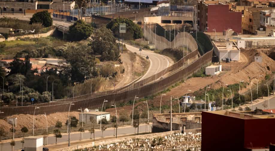 In pics: Over 400 migrants storm border fence in Spain's Melilla ...