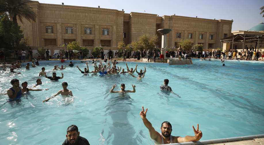 Iraqi protesters take dip in pool after storming presidential palace in ...