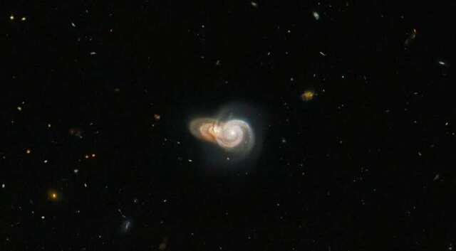 Hubble clicks brilliant photo of two 'overlapping' spiral galaxies ...